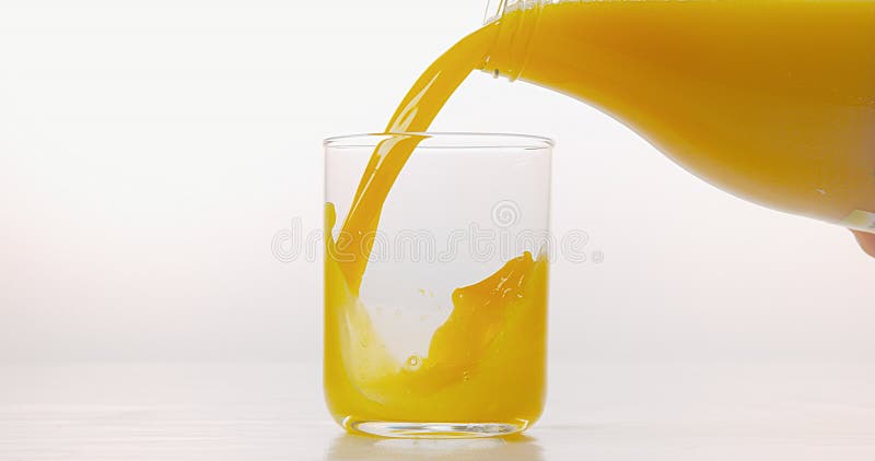 Orange Juice Being Poured into Glass Against White Background Stock ...