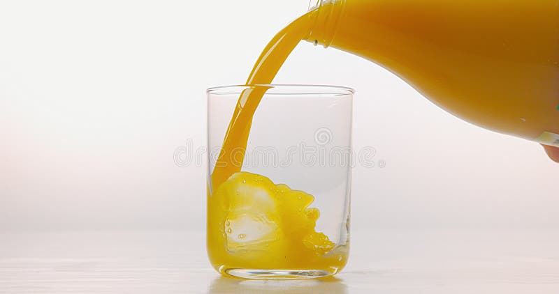 Orange Juice Being Poured into Glass Against White Background Stock ...