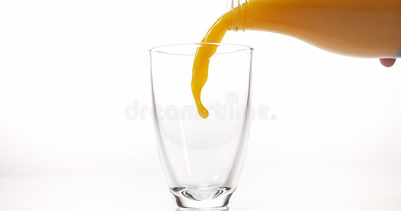 Orange Juice Being Poured into Glass Against White Background Stock ...