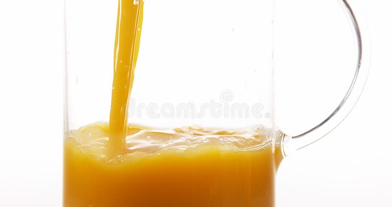 Orange Juice Being Poured into Glass Against White Background Stock ...