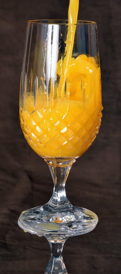 Orange Juice Pouring into a Glass, Forming a Splash Stock Image - Image ...