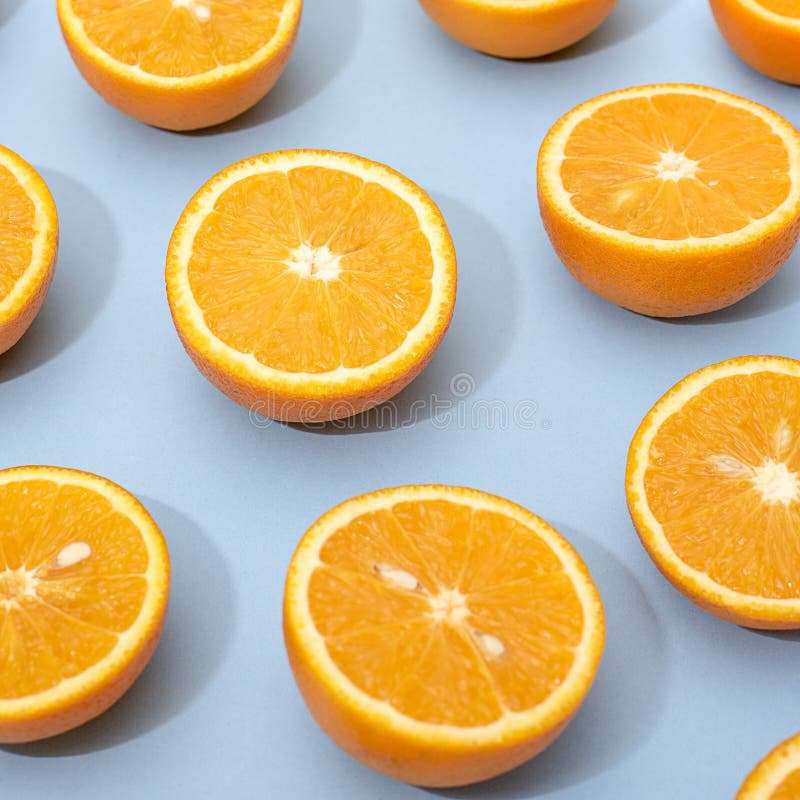 Orange Juicy Oranges Split in Half on Blue Stock Image - Image of slice ...