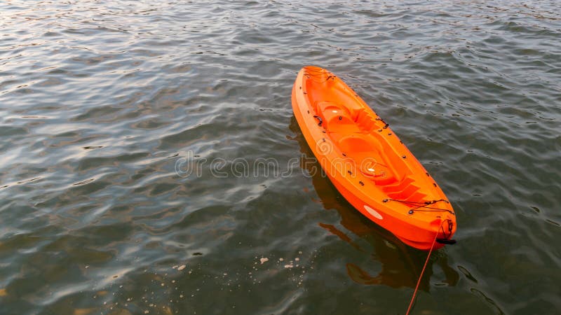Orange kayak on the sea stock photo. Image of beach - 185608190