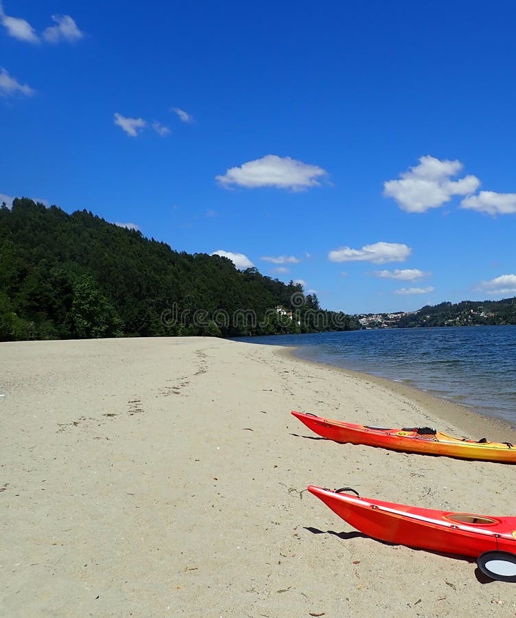 Orange Kayaks on the Sand on Shore of River Stock Image - Image of sand ...