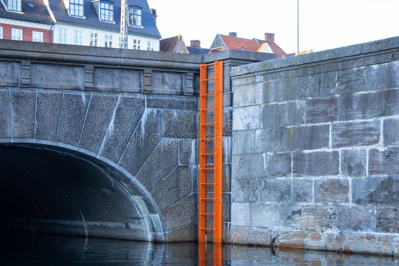 An Orange Ladder Fixed in a Water Canal at the Arched Stone Bridge in ...