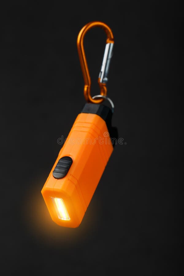 Orange Led Flashlight with a Carabiner on a Black Background. LED ...