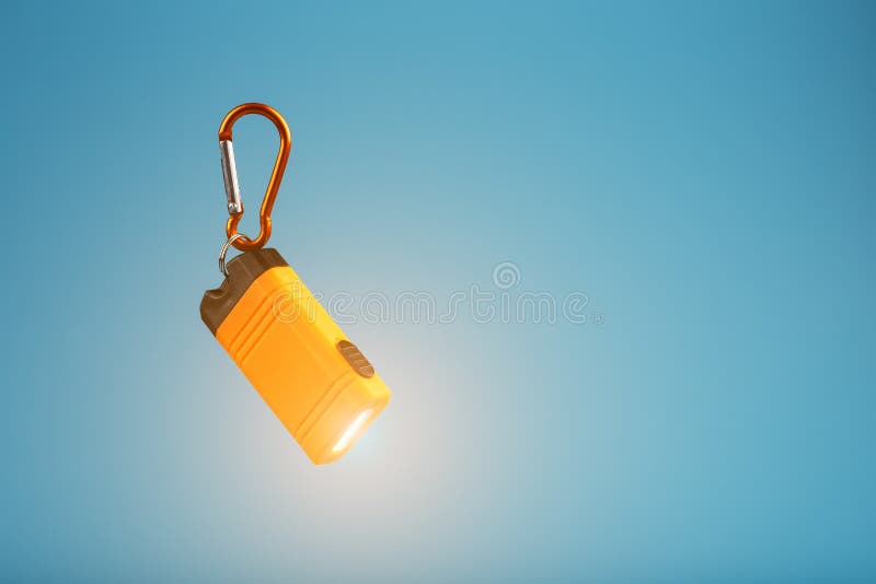 Orange Led Flashlight with a Carabiner on a Blue Background. LED Lights ...