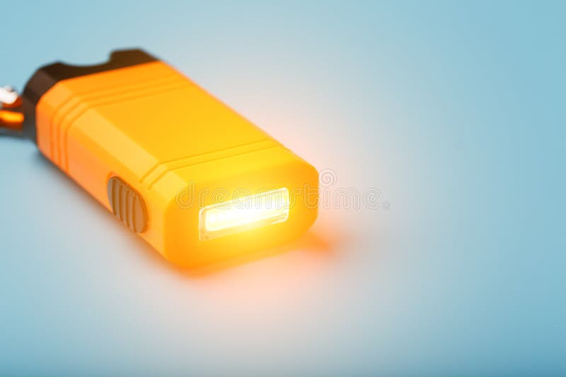 Orange Led Flashlight with a Carabiner on a Blue Background. LED Lights ...