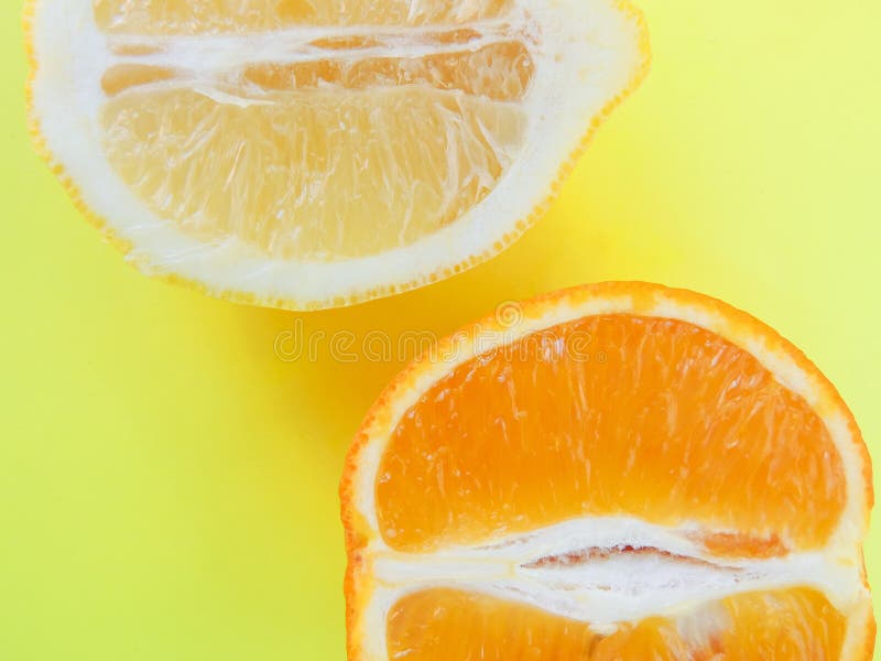 Orange and Lemon Close-up Against a Yellow Background. Stock Image ...