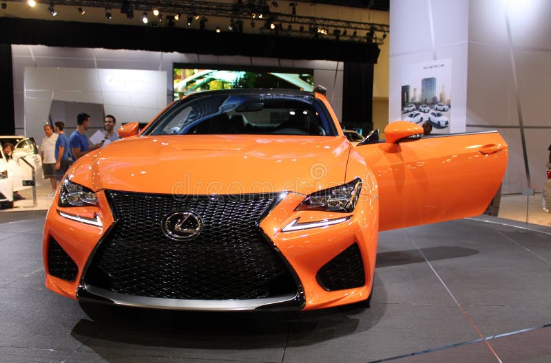 Orange Lexus Sportcar Rides On The Road. Against A Background Of ...