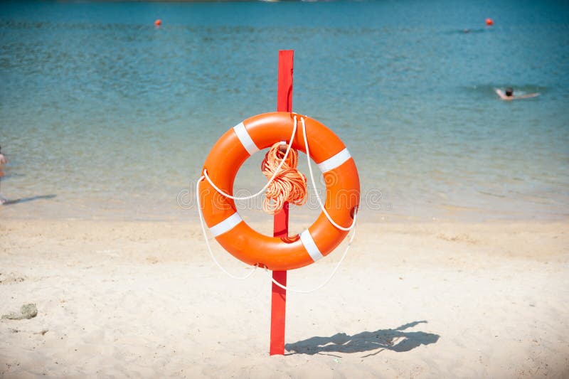 Orange Life Buoy on the Sea or Ocean. Sunny Sandy Beach Stock Photo ... Orange Life Buoy on the Sea or Ocean. Sunny Sandy Beach Stock Photo ...