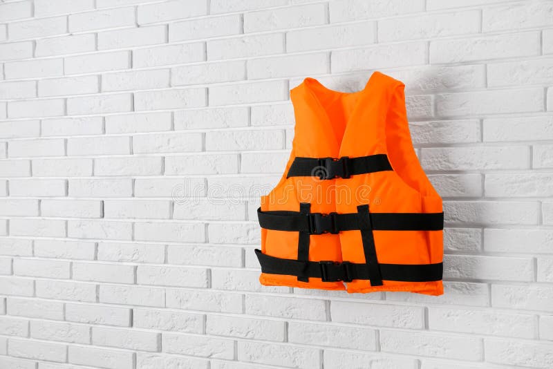 Orange Life Jacket on White Brick Wall. Space for Text Stock Photo ...