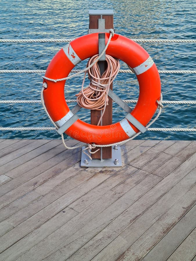 Red Life Ring on Wooden Deck Stock Photo - Image of detail, ocean ...