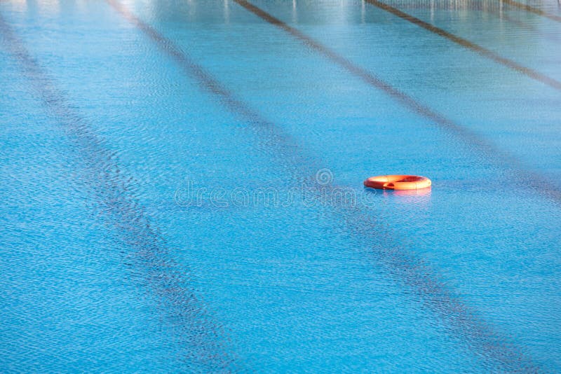 Orange Lifebuoy Floating on a Pool Stock Image - Image of floating ...
