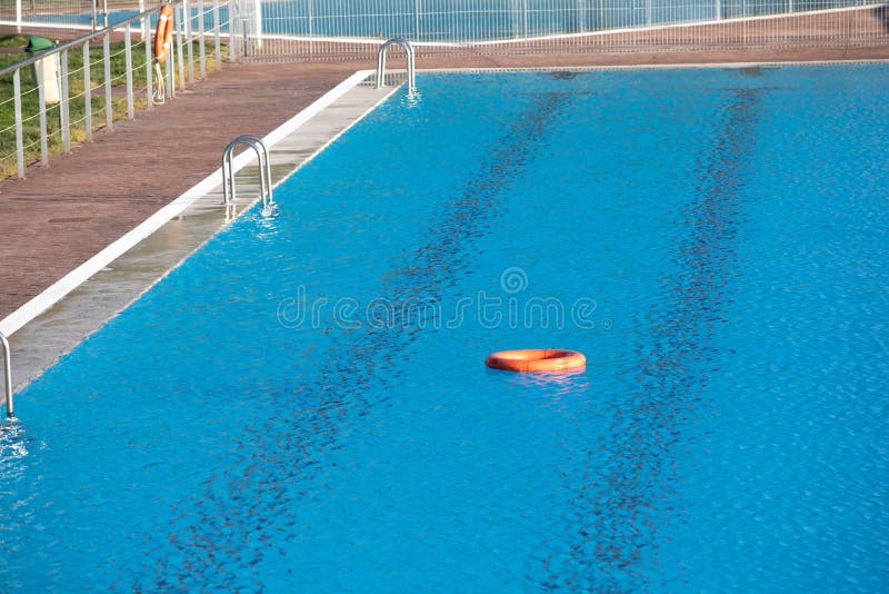 Orange Lifebuoy Floating on a Pool Stock Image - Image of lifesaver ...
