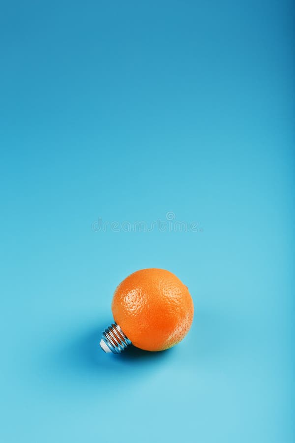 Orange Light Bulb on a Blue Background. the Concept of Fruit Ideas ...