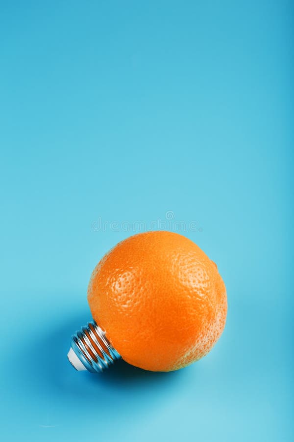 Orange Light Bulb on a Blue Background. the Concept of Fruit Ideas ...