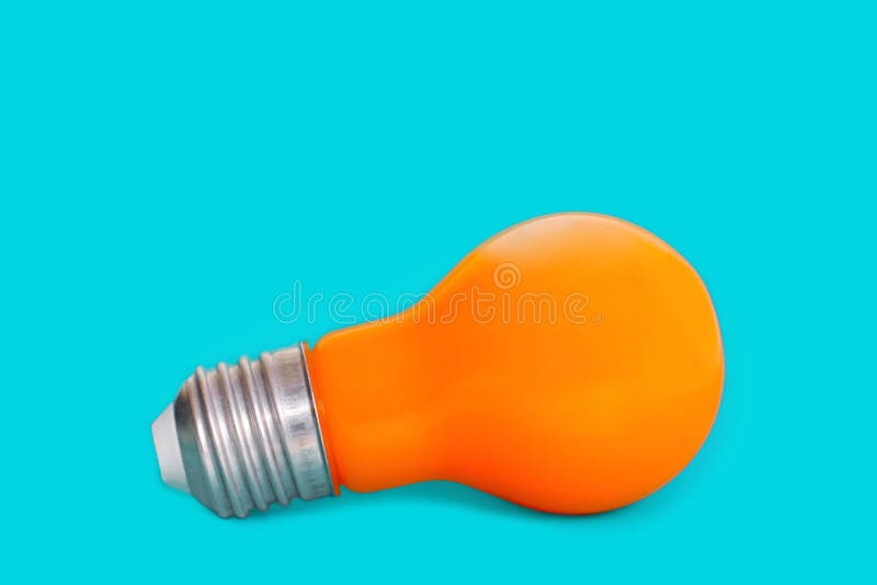 Orange Light Bulb Isolated on Blue Background Stock Photo - Image of ...