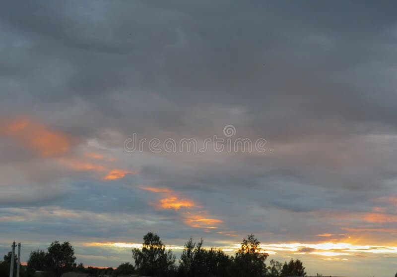 Unique Clouds, Illuminated by the Rays of the Setting Sun. Stock Photo ...