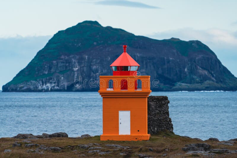 Orange Lighthouse with Huge Islet in the Background Stock Photo - Image ...