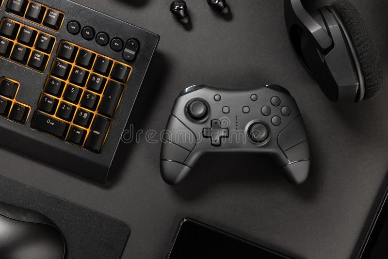 Orange Lit Keyboard with Controller Amidst Various Wireless Devices ...