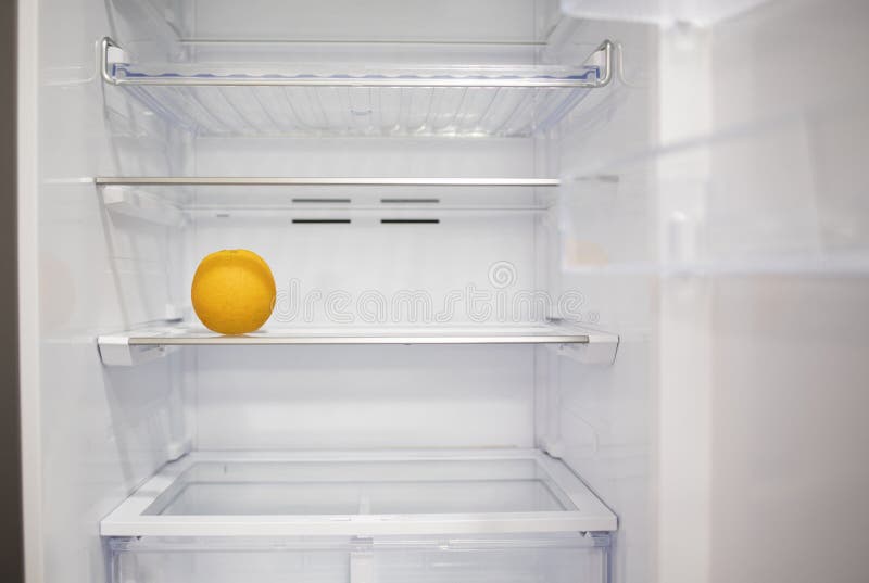 Orange Lying Against the Background of a White Empty Fridge Shelf Stock ...