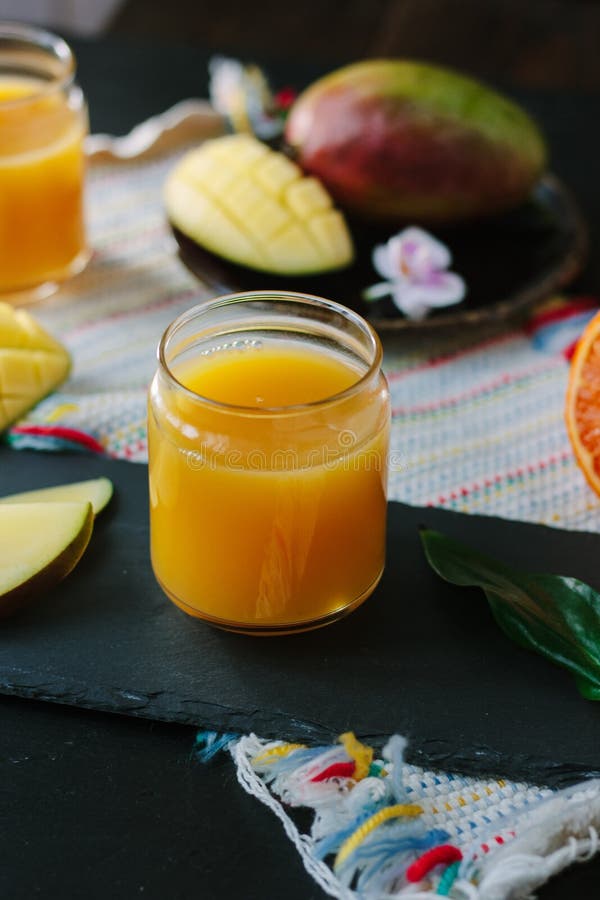 Orange and Mango Fruit Juice Over Black Slate. Stock Photo - Image of ...