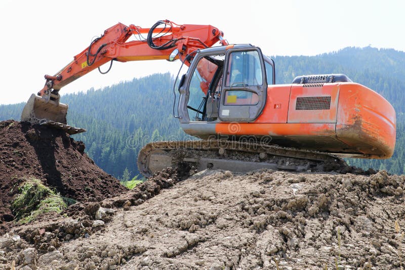 Orange Mechanical Digger Working on a Field Stock Image - Image of ...