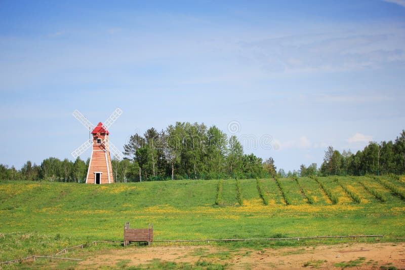 An Orange Mill Stands in a Green Field Stock Image - Image of ...