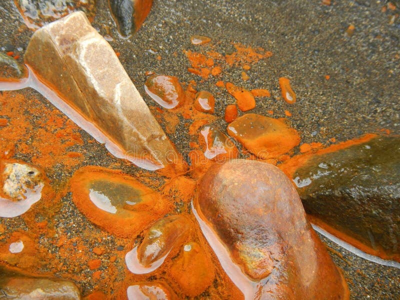 Orange Minerals Drape the Sand and Rocks Stock Photo - Image of nature ...