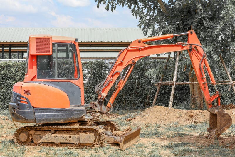 The Orange Mini Backhoe Stop in Construction Site Stock Photo - Image ...