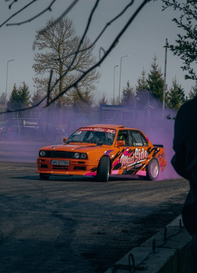 Orange, Modified Car Performing a Burnout, Spinning the Back Tires ...