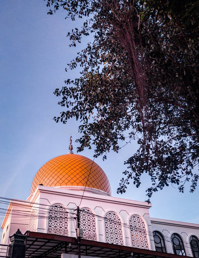 An orange Mosque dome stock photo. Image of clearsky - 340297932