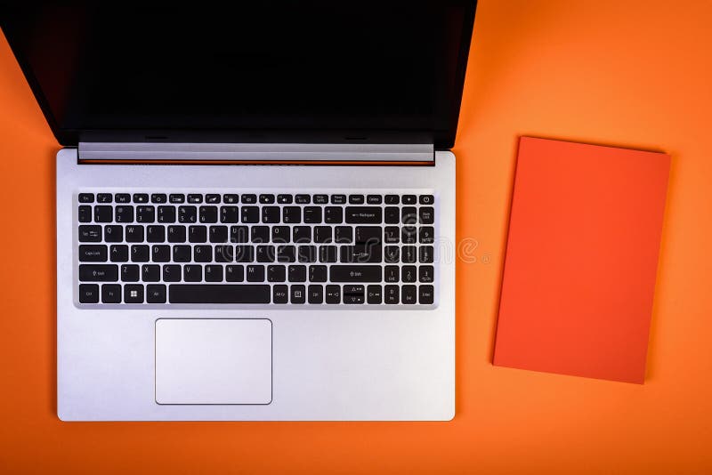 Orange Notebook and Laptop on Orange Background. Stock Photo - Image of ...
