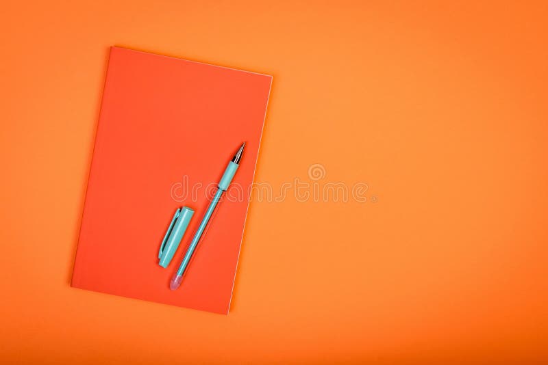 Orange Notebook and Pen on Orange Background. Stock Image - Image of ...