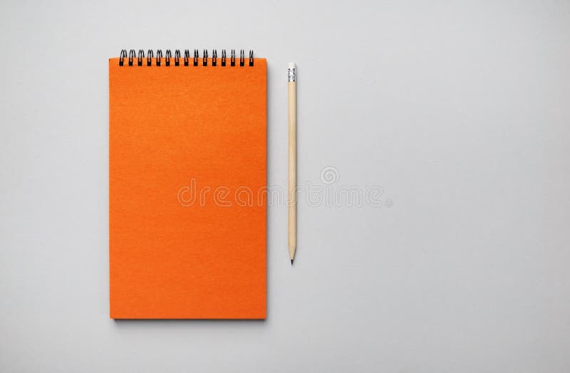 Orange notebook and pencil stock photo. Image of portfolio - 277031314