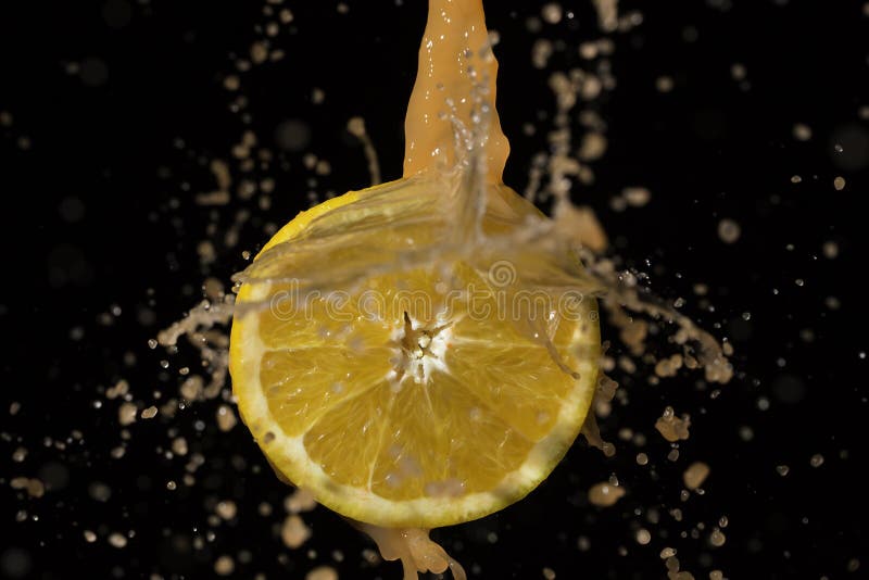 Orange and Orange Juice Splash on a Black Background Stock Image ...