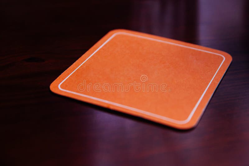 Orange Paper Coaster on Wooden Table Stock Photo - Image of design ...