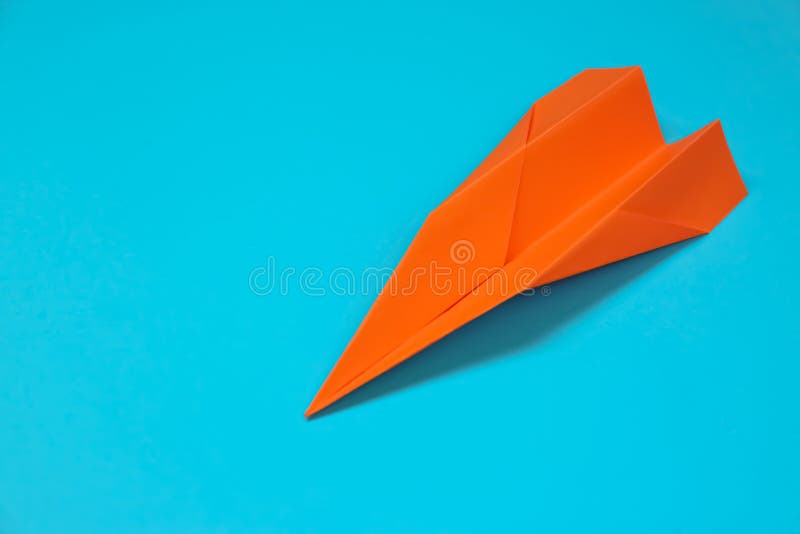 Orange Paper Plane on Light Blue Background, Space for Text Stock Photo ...