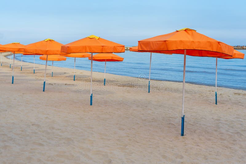 Orange Parasols on the Beach Stock Photo - Image of summer, parasol ...