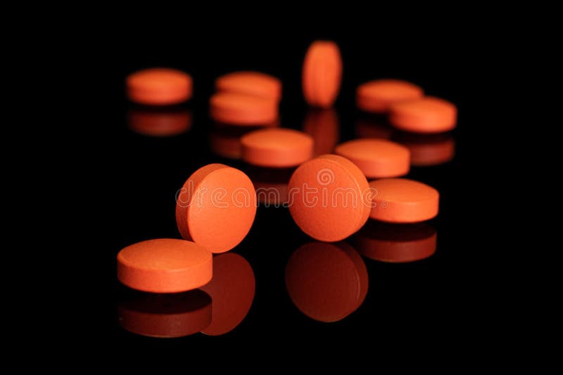 Orange Pharmacy Tablet Isolated on Black Glass Stock Photo - Image of ...