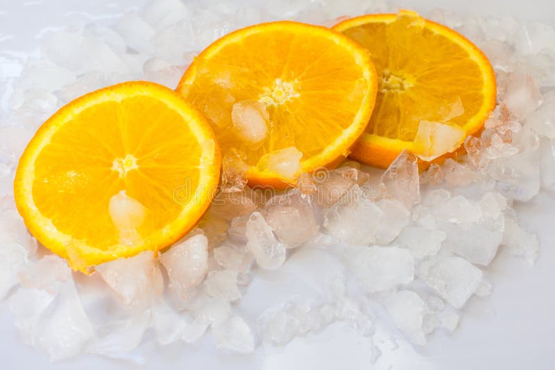 Orange in pieces of ice stock photo. Image of cubes - 143909656