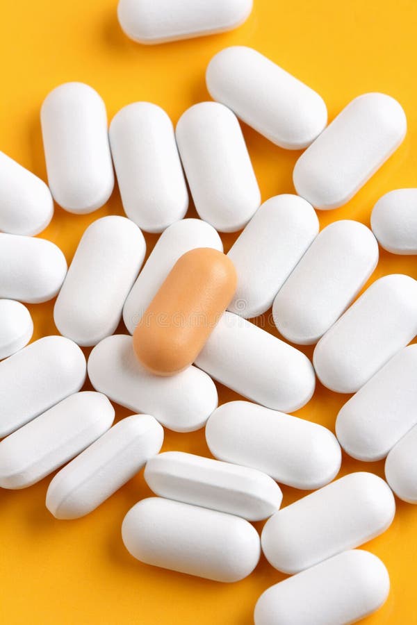 Orange pill among white stock image. Image of pharmaceutics - 191545891