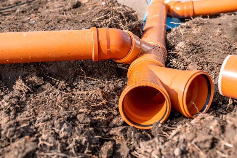 Orange Plastic PVC Pipes in the Ground Stock Image - Image of ...