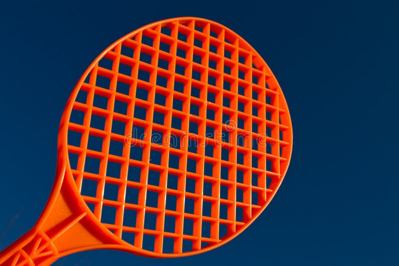 Orange plastic racket stock photo. Image of racquet - 123352896
