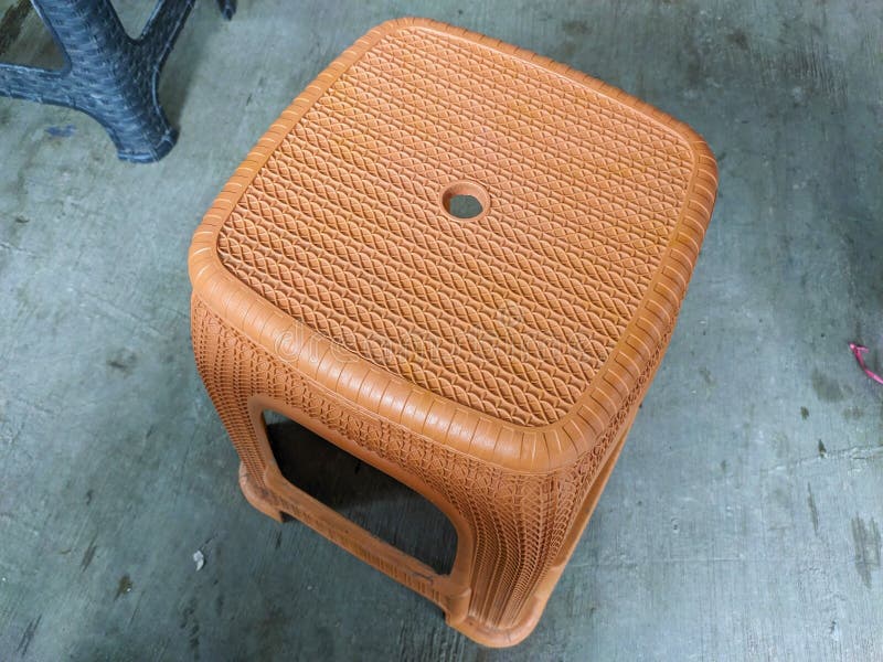 An Orange Plastic Stool with a Woven-pattern Texture and a Central Hole ...