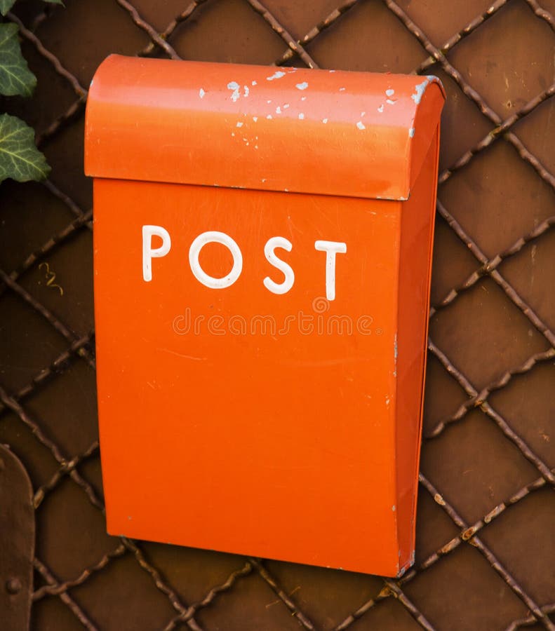 Orange post box on a wall stock photo. Image of white - 77148314