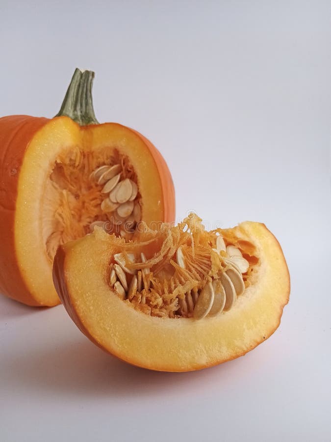 Orange Pumpkin with a Slice Cut Out Isolated on a White Background ...
