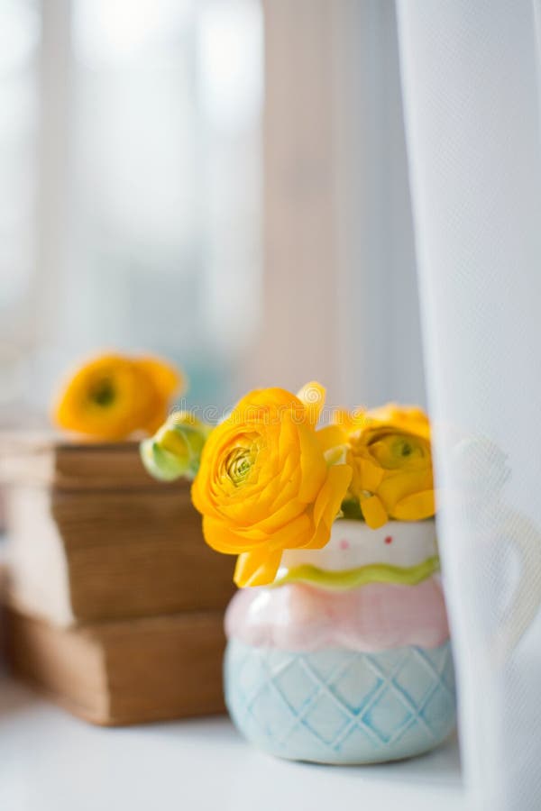 Orange Ranunculus in Cute Small Pitcher and Stack of Vintage Books ...