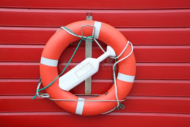 Orange Red Life Saving Ring Against a Red Painted Wooden Wall, with ...